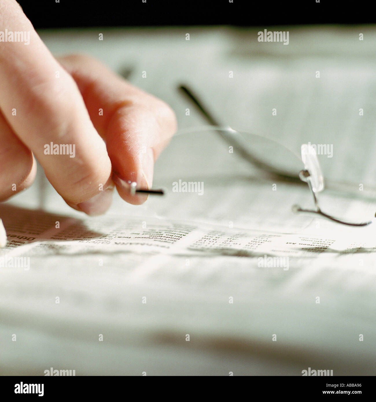 A hand holding a pair of spectacles Stock Photo - Alamy