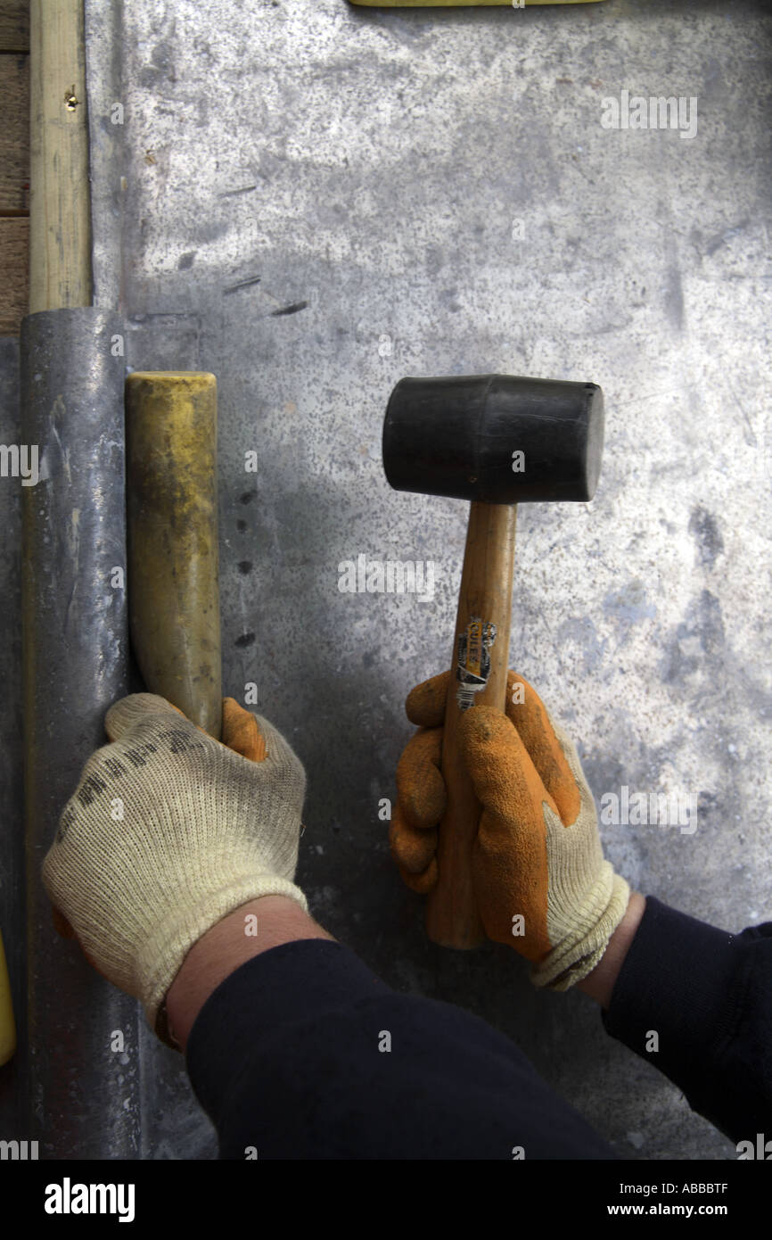 Image of man bossing and dressing lead sheet into the bay of a practice ...
