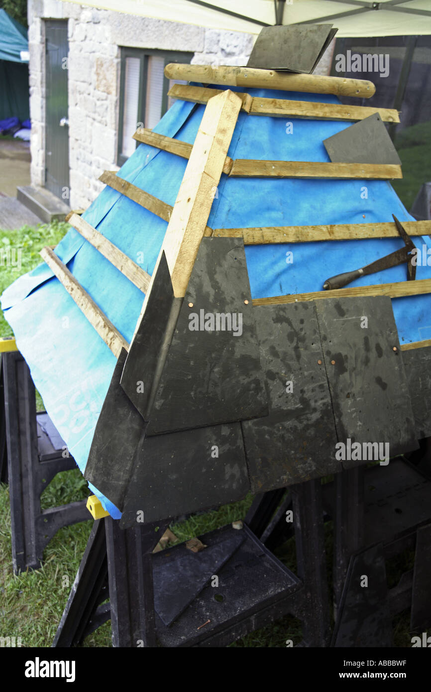 Training rig for slating and tiling with a mitred hip being produced ...
