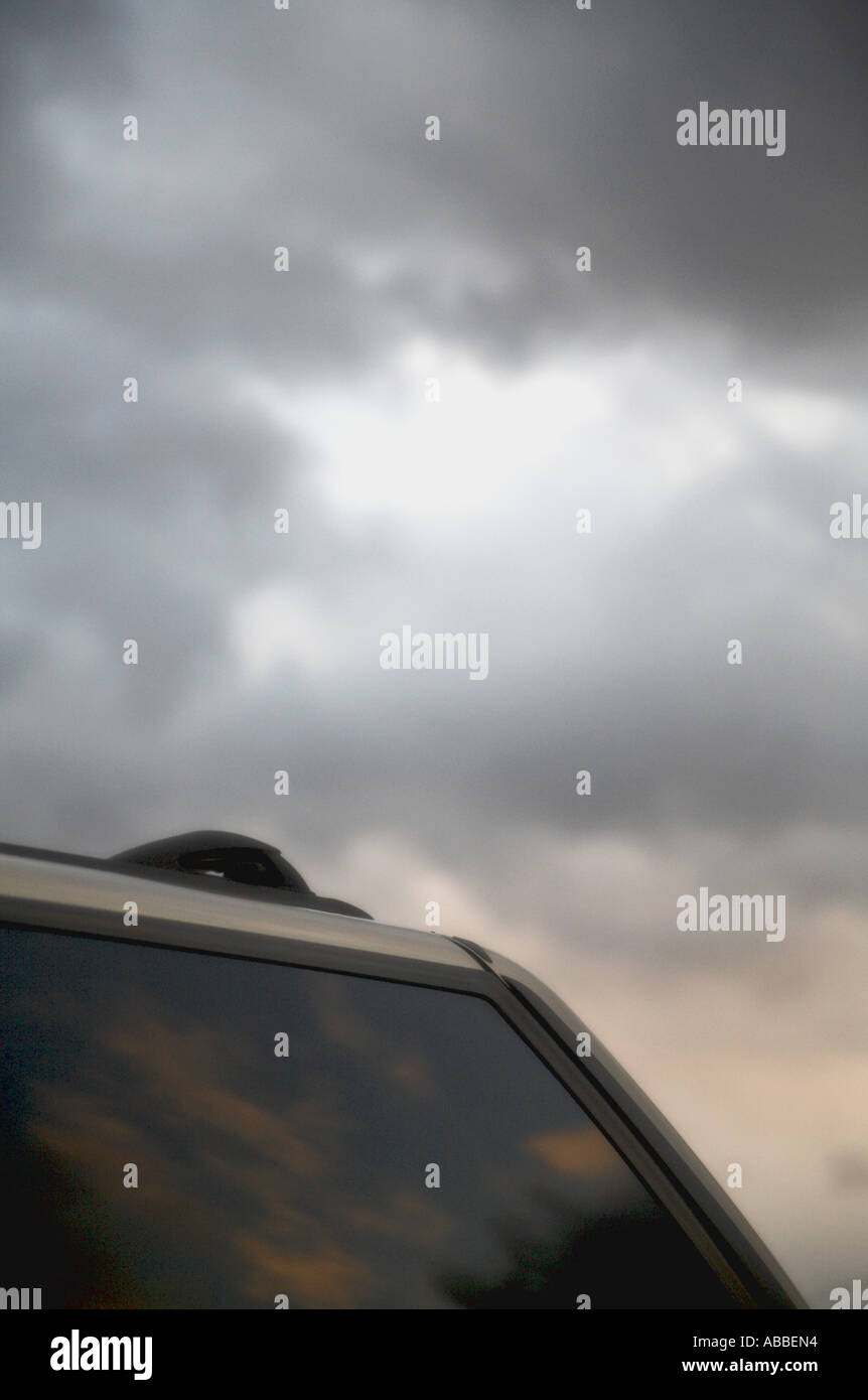 Section of vehicle reflecting clouds in window Stock Photo - Alamy