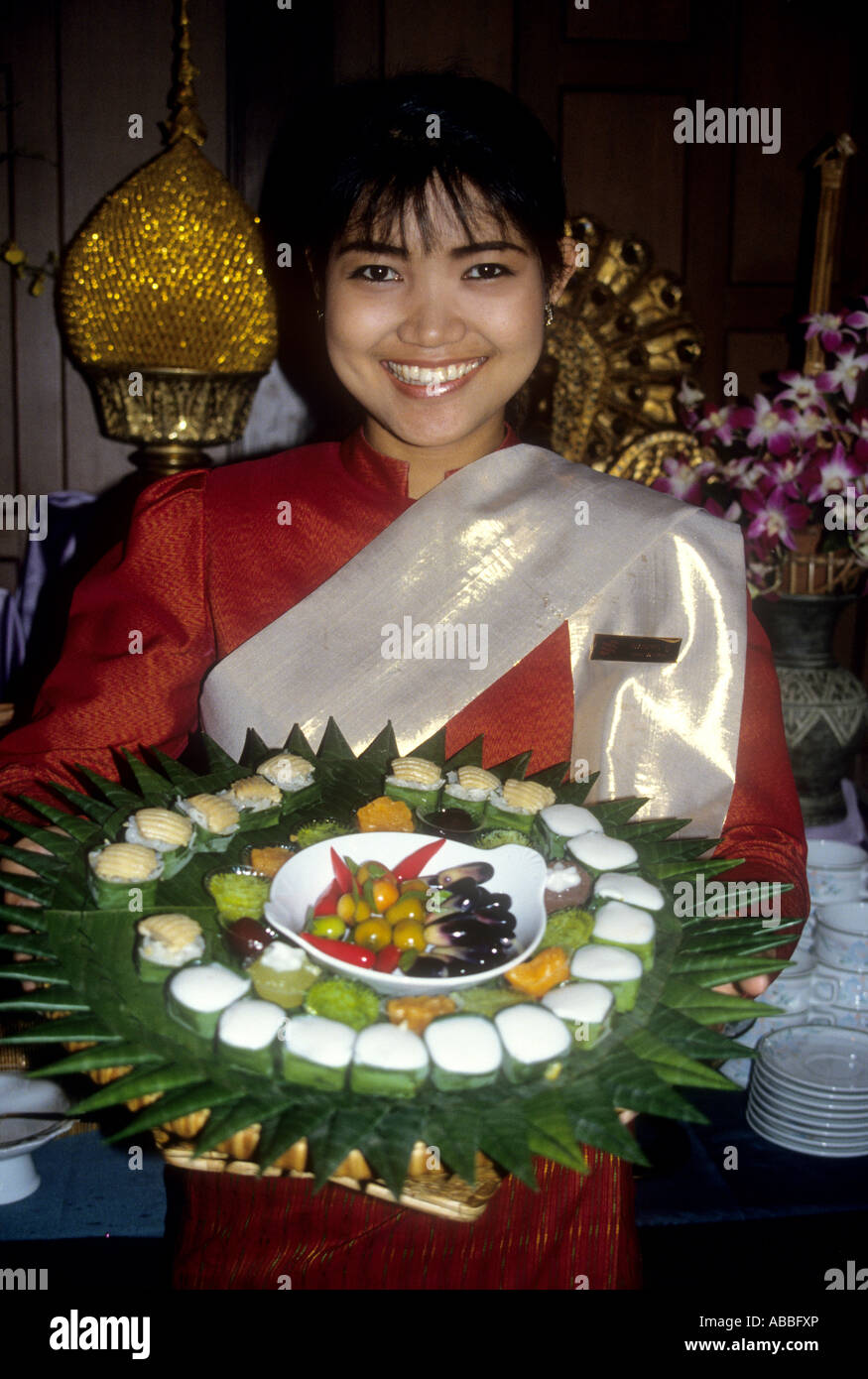 beautiful smiling Thai Girl offering typically beautifully prepared ...