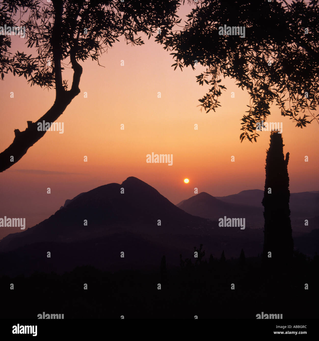 Sunset from Kaiser’s Throne with trees and hills silhouetted and calm ...