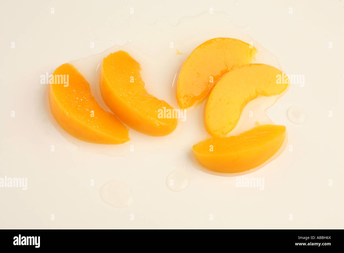 Peach segments against a white back ground Stock Photo - Alamy