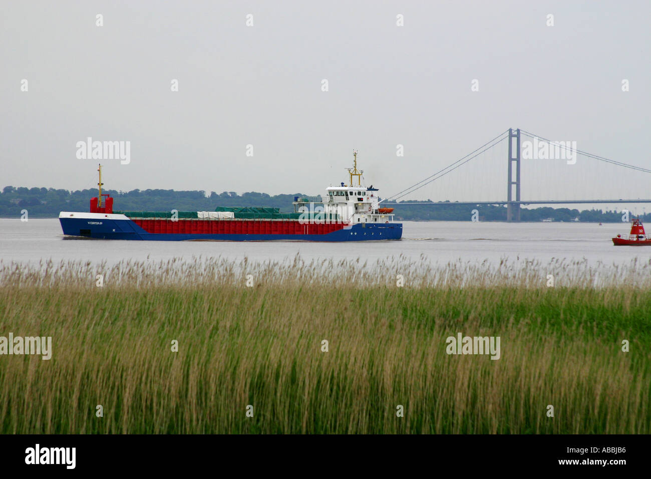 Coaster transport ship in the River Humber with the Humber Bridge in ...