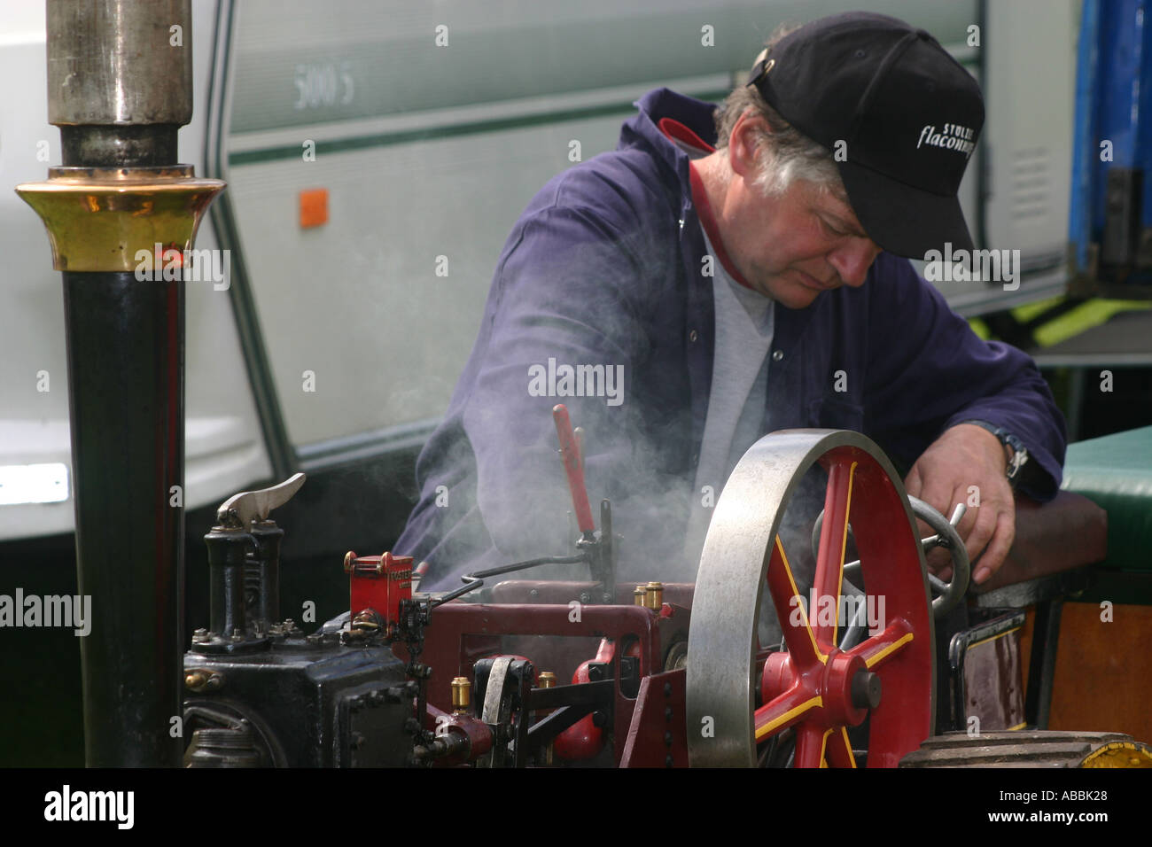 Man working on small model steam traction engine Stock Photo - Alamy