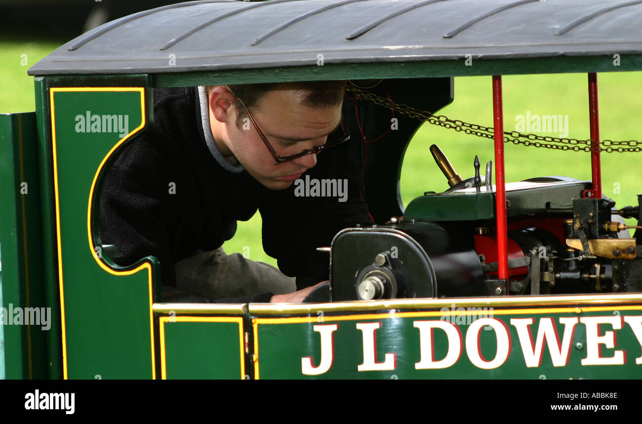 Man working on inside of scale model steam traction engine Stock Photo ...