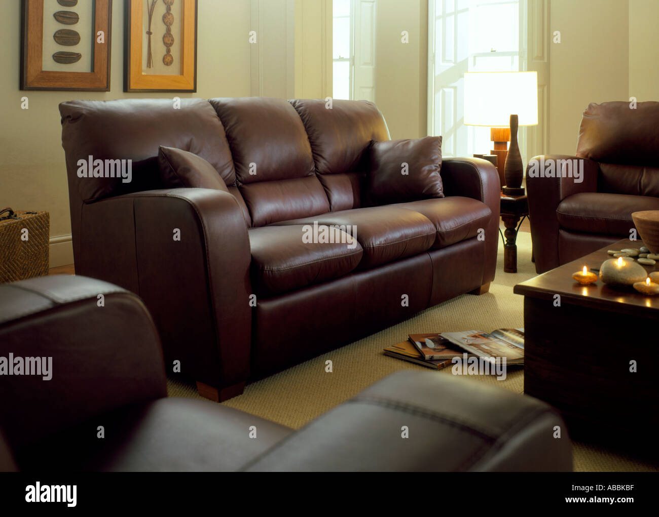 Cosy modern living room with brown leather sofa Stock Photo - Alamy