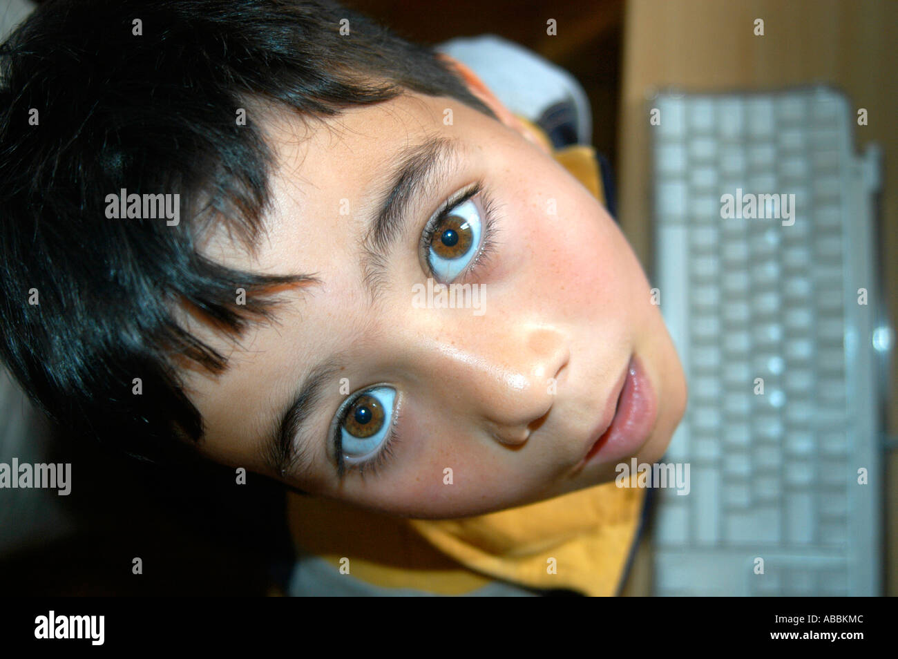 Model Released: Young boy in the computer, looking up at the camera ...