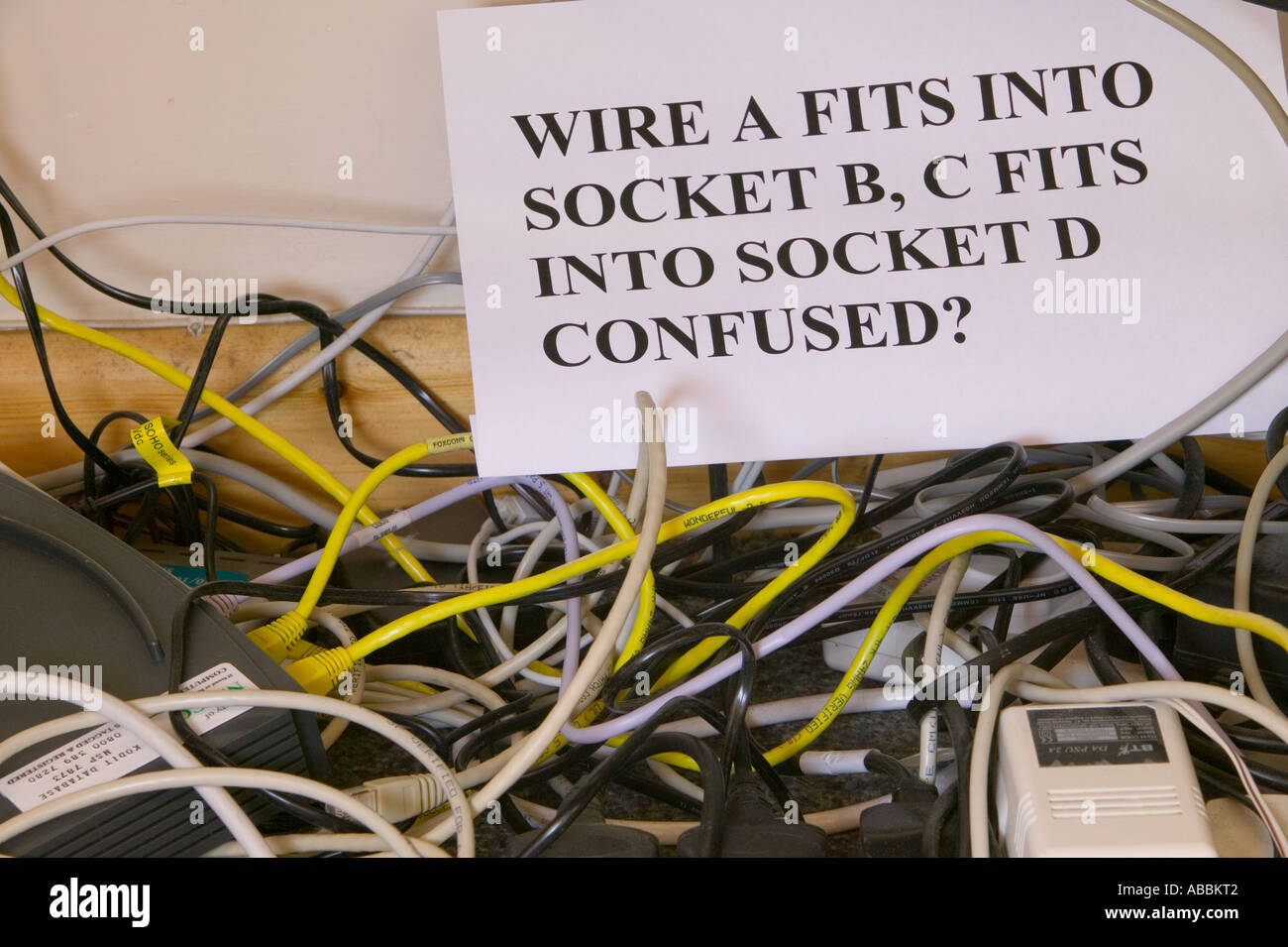 a tangle of computer wires underneath a desk in a workplace Stock Photo ...