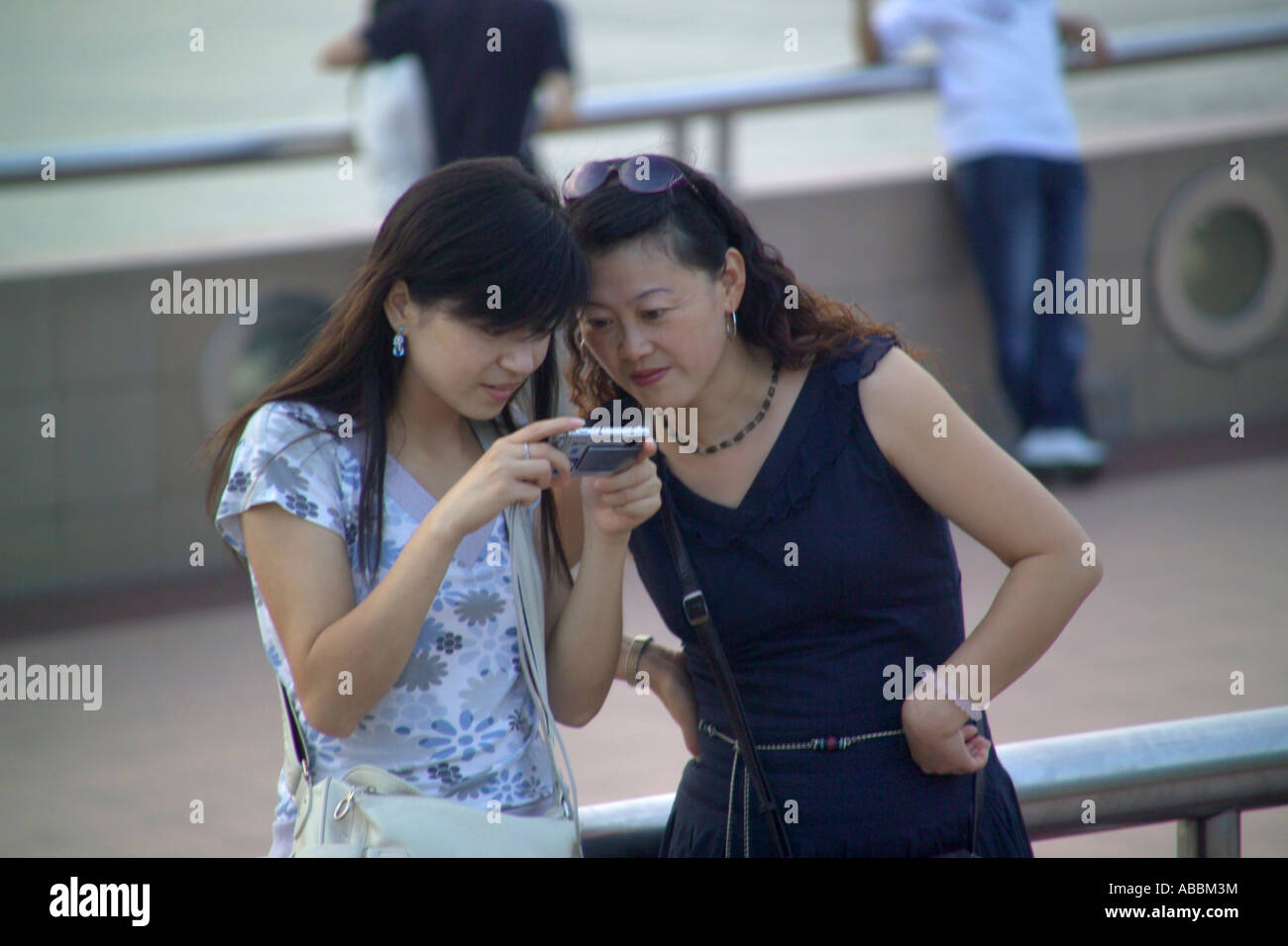 Chinese girls looking at their pictures on a digital camera Stock Photo ...