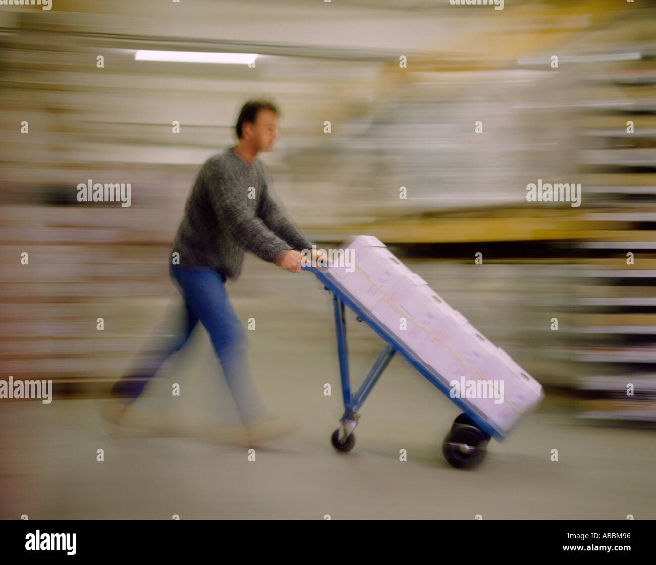 Man pushing trolley Stock Photo - Alamy