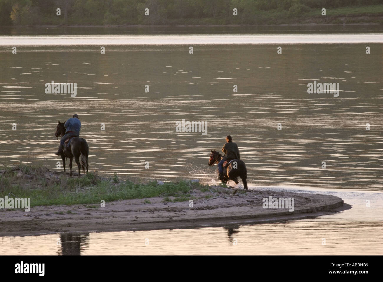 Horse riders on shore of lake in scenic Saskatchewan Canada Stock Photo ...