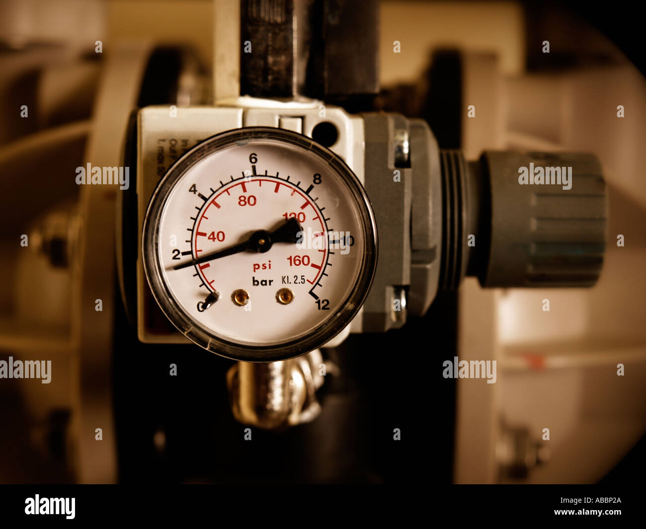 Round industrial pressure meter dial needle showing almost two bar or ...