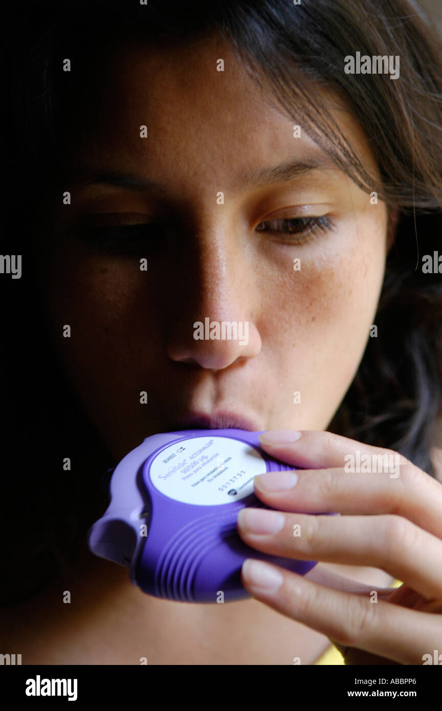 Model Released: Young woman using Seretide Accuhaler, a medication for ...