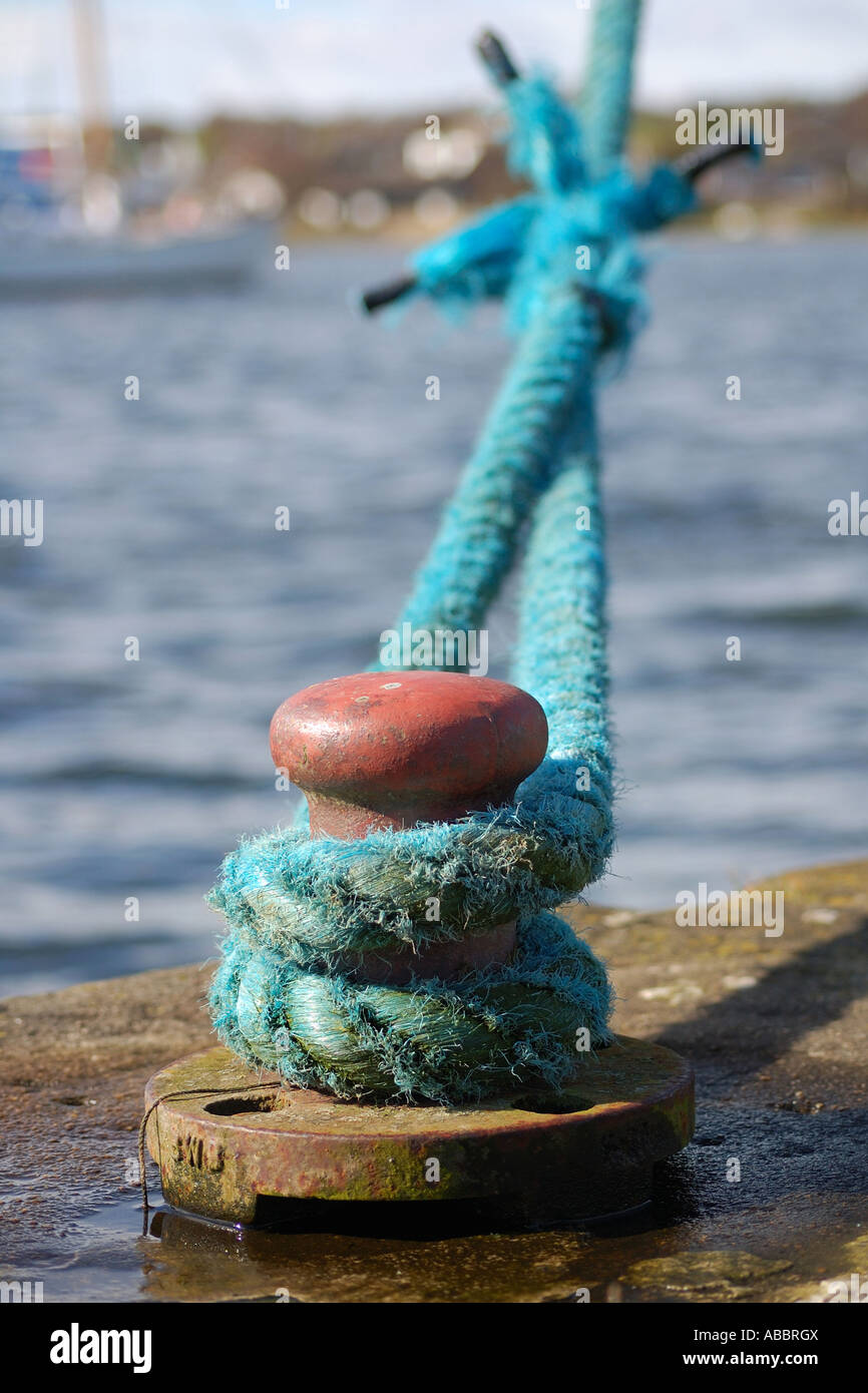 Blue boat rope tied to dock Stock Photo - Alamy