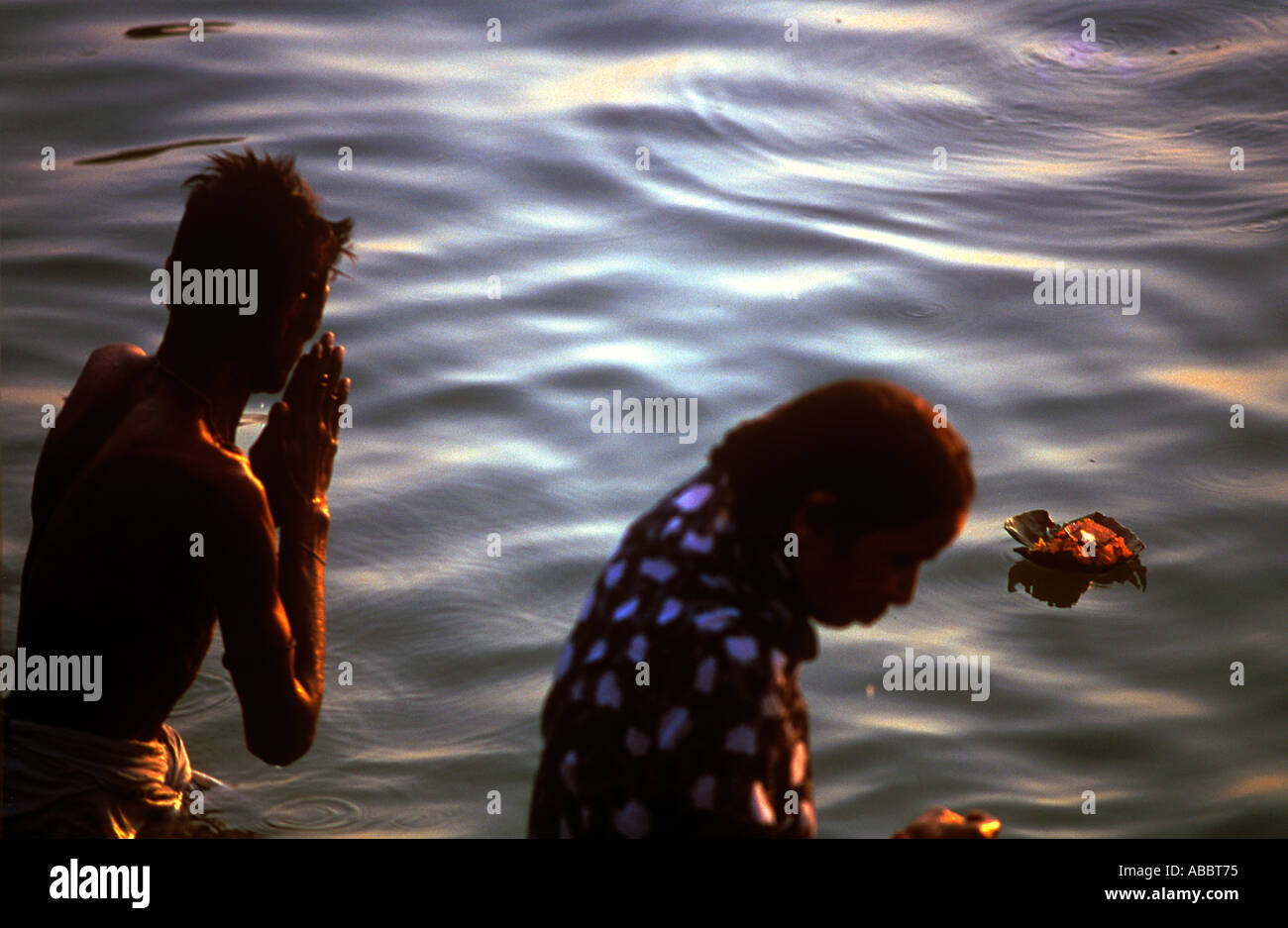Indian couple bathing doing namaskar prayer to sun in ganges river ...