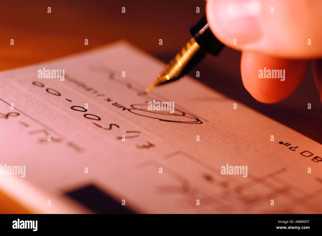 Person signing cheque Stock Photo - Alamy
