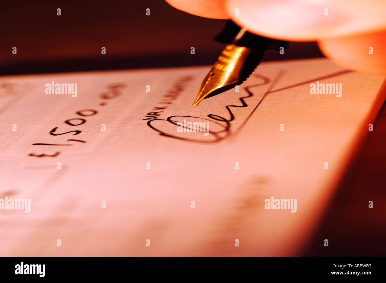 Person signing cheque Stock Photo - Alamy