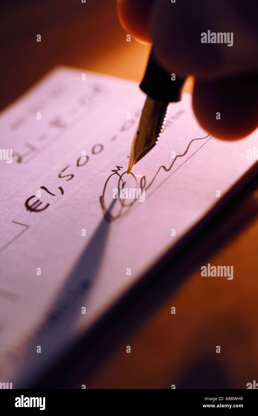 Person signing cheque Stock Photo - Alamy