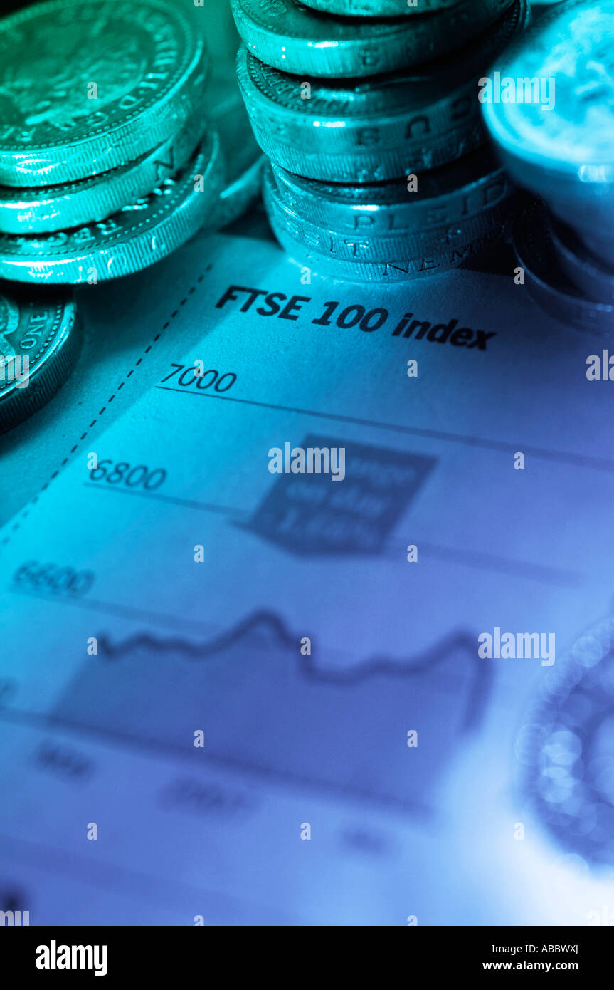 Pound coins on share index report in financial paper Stock Photo - Alamy
