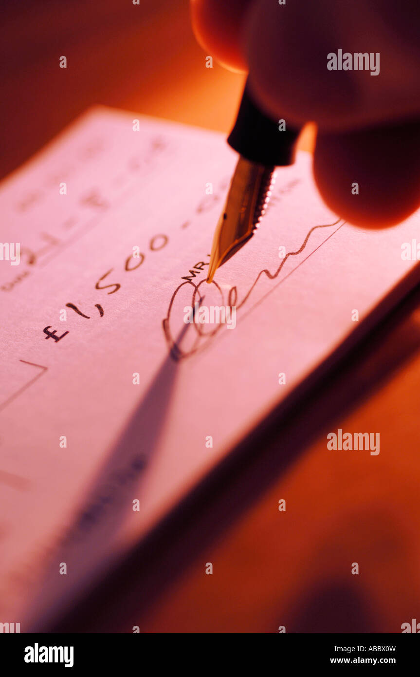 Person signing cheque Stock Photo - Alamy