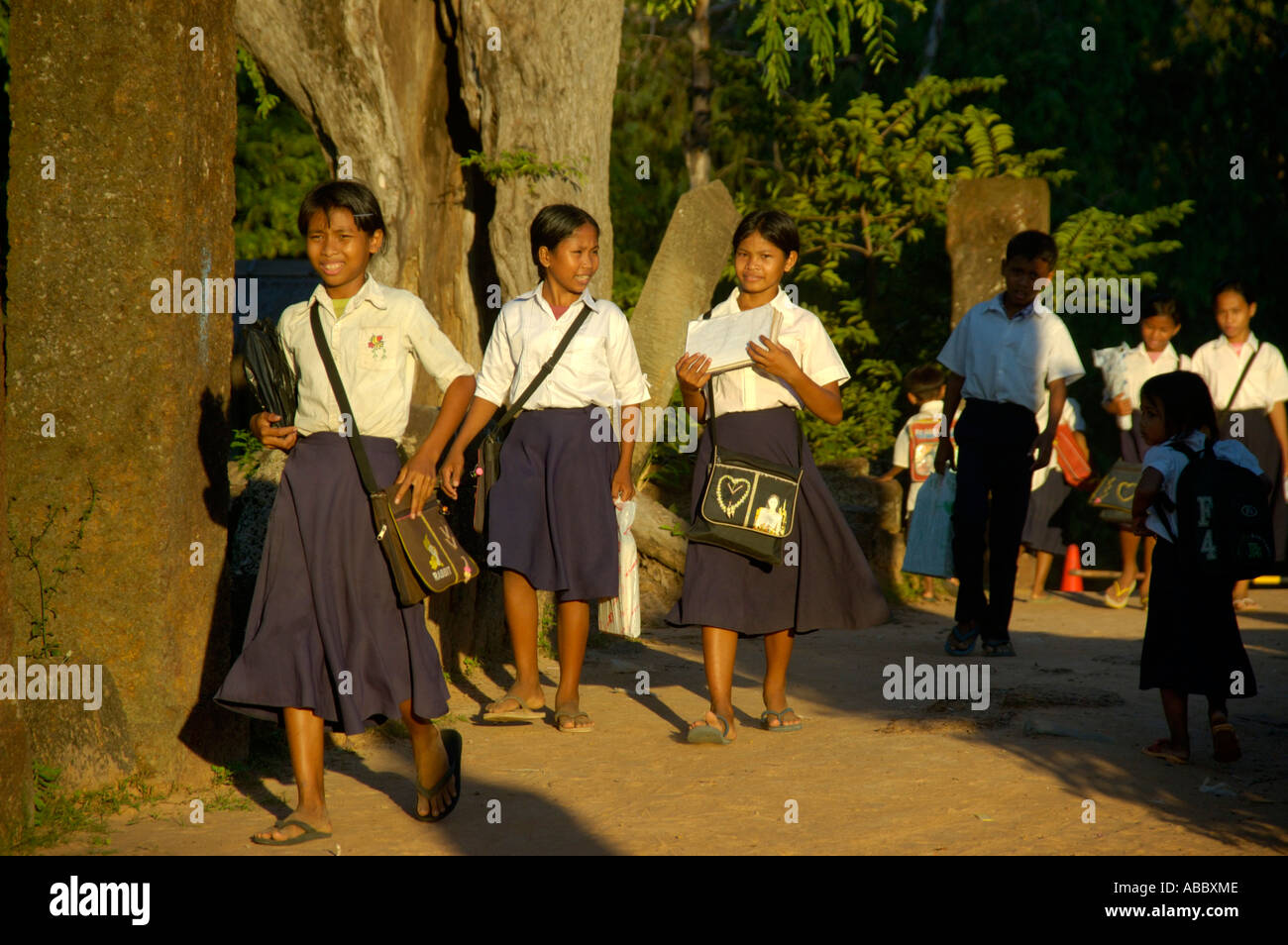 Girls wearing school uniform on the way to school Roluos Angkor Siem ...