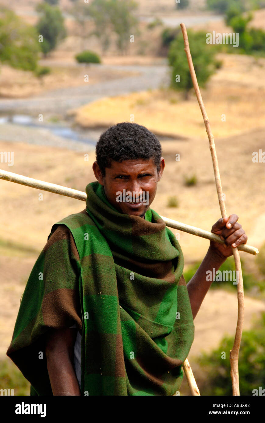 Shepherd with sticks and cape near Bahir Dar Ethiopia Stock Photo - Alamy