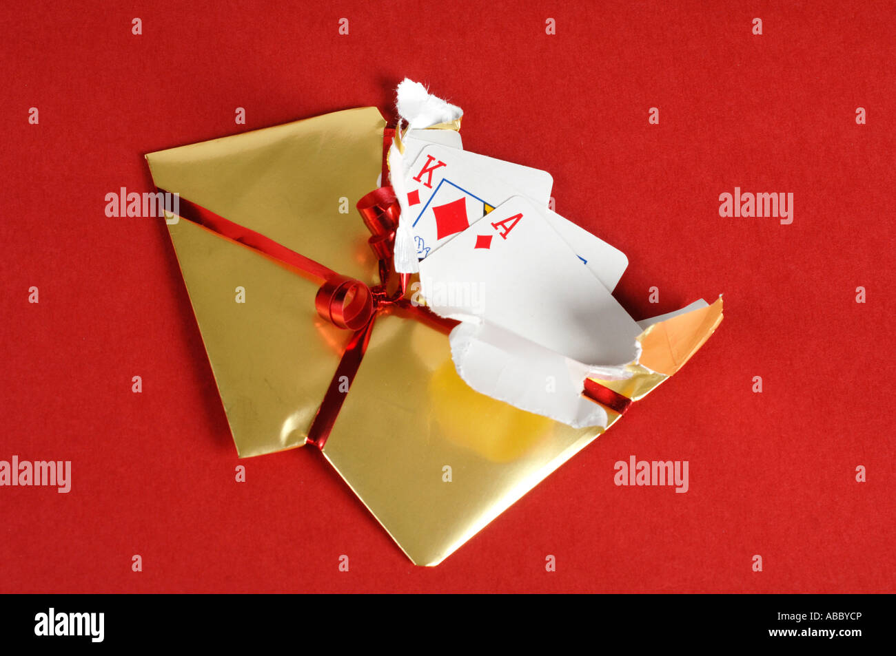 Gift wrapped hand of cards partially unwrapped showing Ace and King of ...