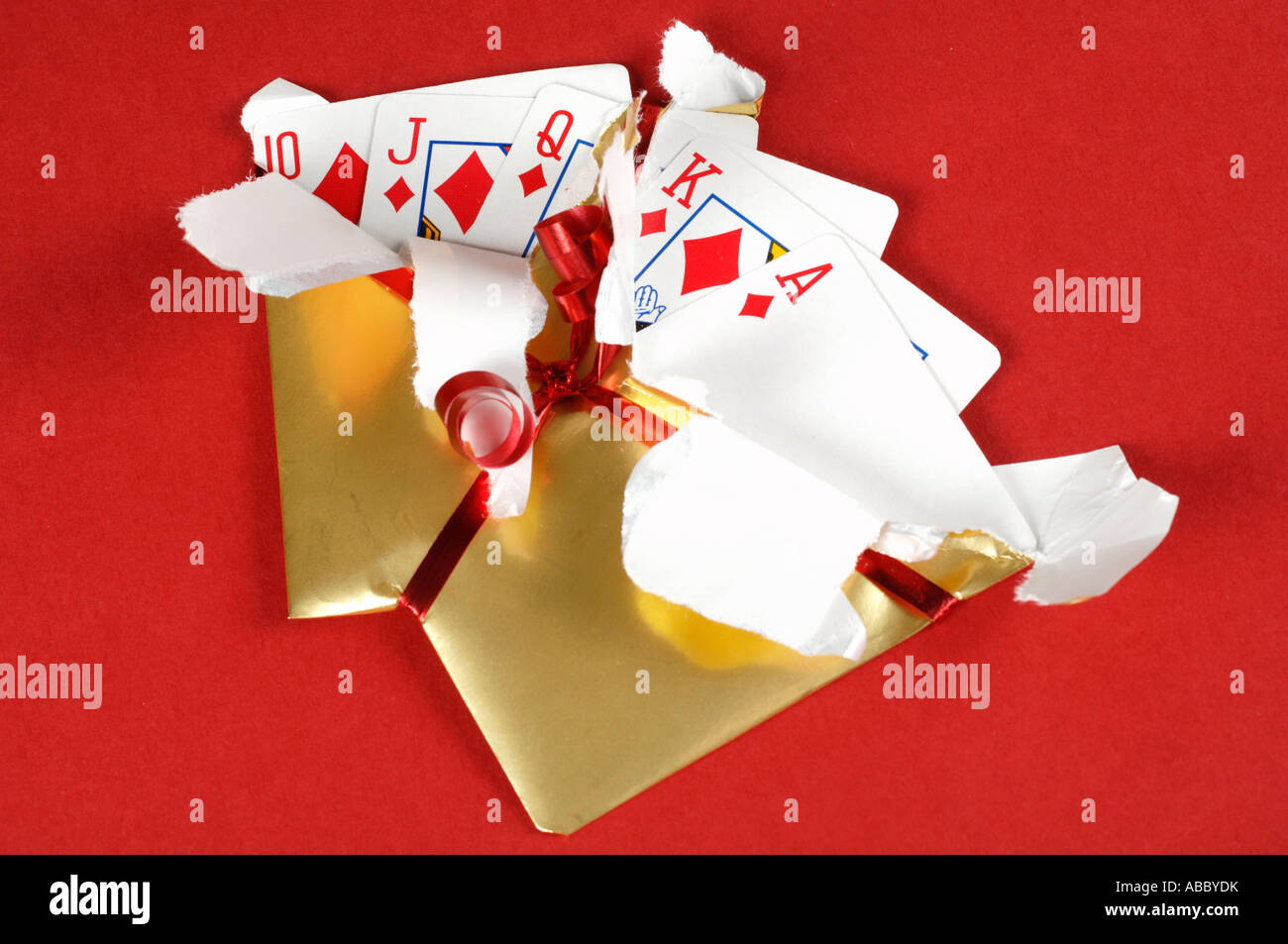 Gift wrapped hand of cards partially unwrapped showing Royal Flush ...
