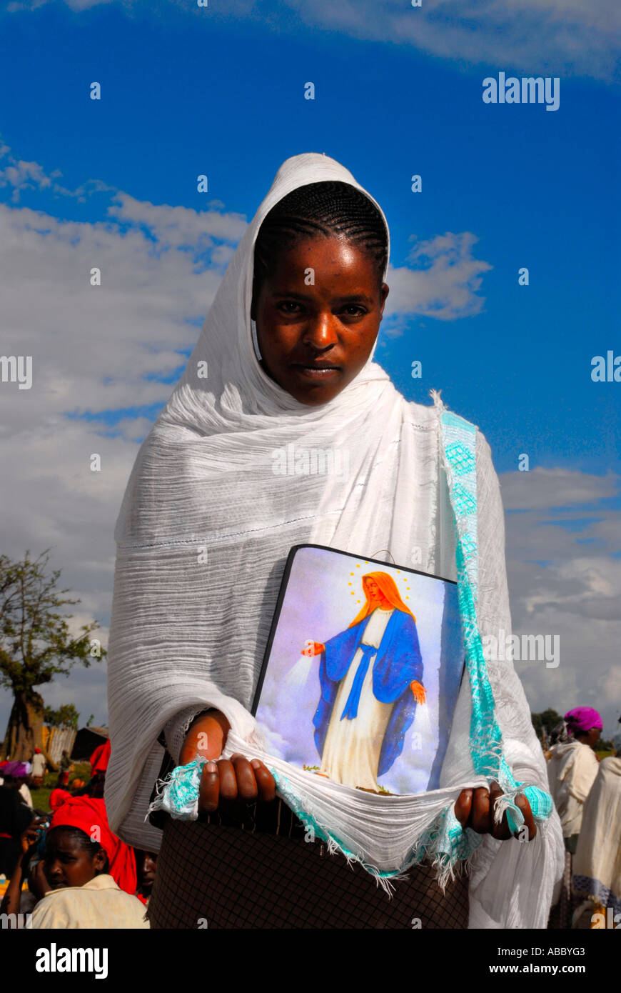 Young woman of the Dorze people believer dressed in a white cape ...