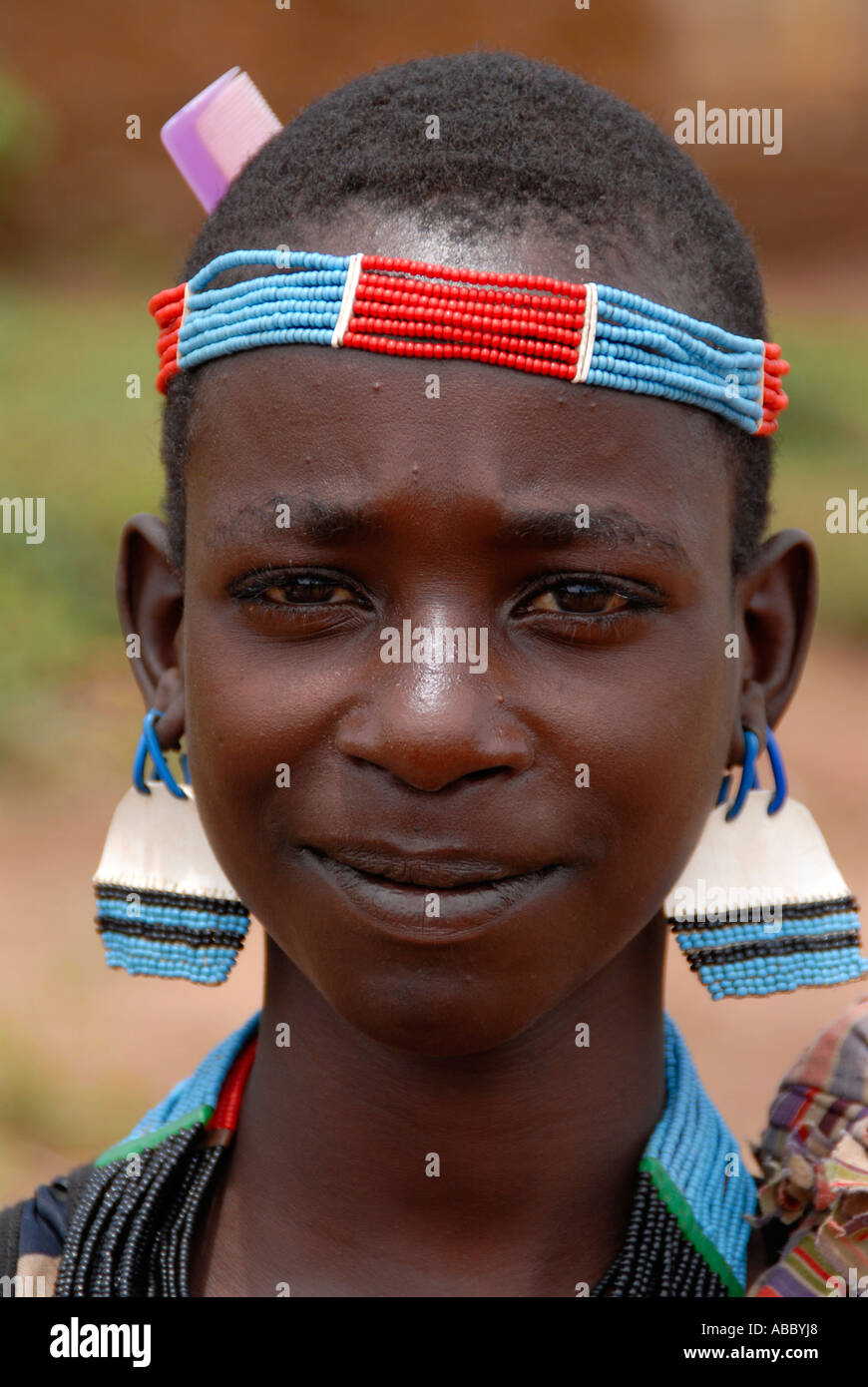 Portrait boy of the Banna people with colourful necklace head and ear ...
