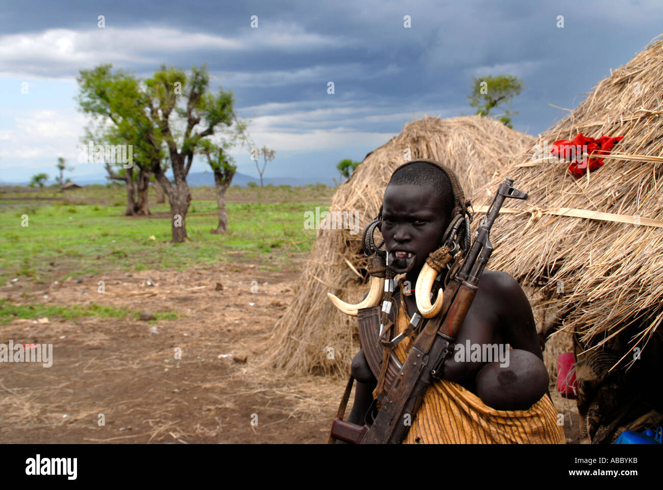 Woman of the Mursi people wearing head decoration of animal teeth ...
