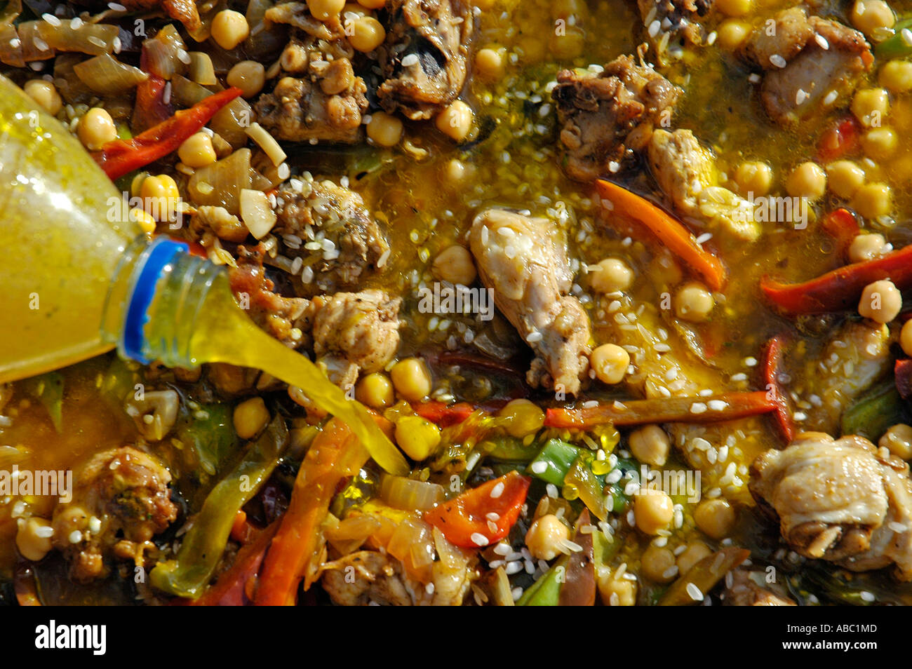 Cooking the spanish speciality paelle in a pan, Spain Stock Photo - Alamy