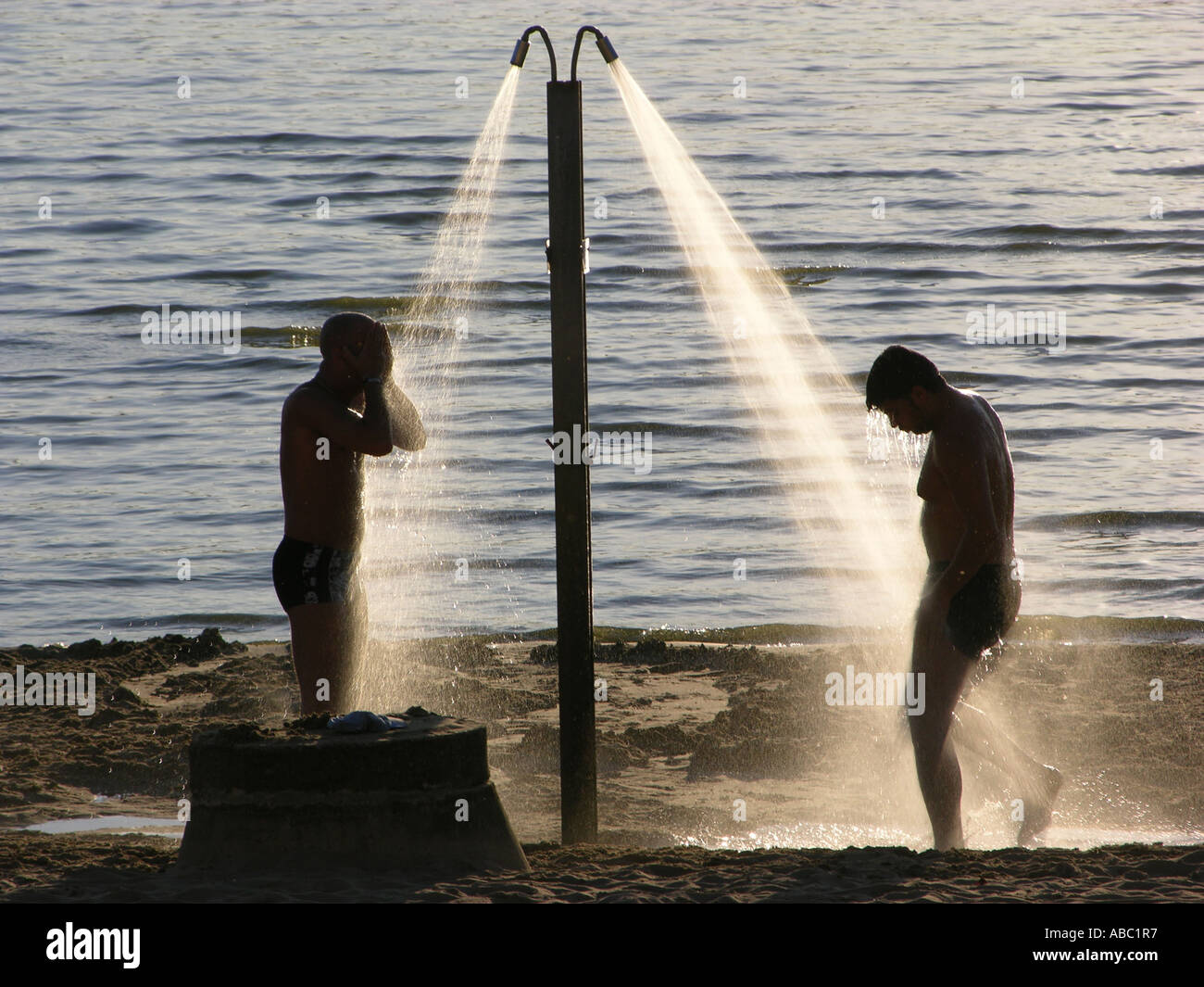 Two young people shower in the open air at Strandbad Wannsee, Berlin ...