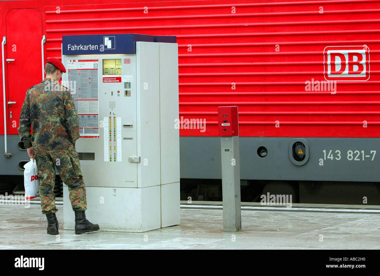German soldier stand at a train ticket machine, Germany Stock Photo - Alamy