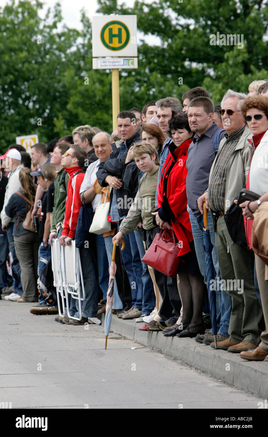 Crowd waiting at a bus stop to ILA 2006 in Berlin Stock Photo - Alamy