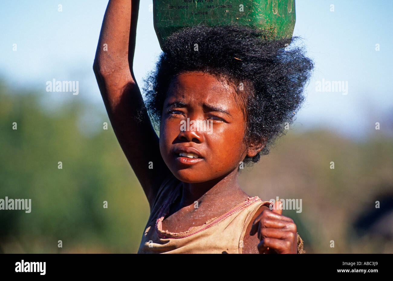 Child carrying water, Madagascar Stock Photo - Alamy