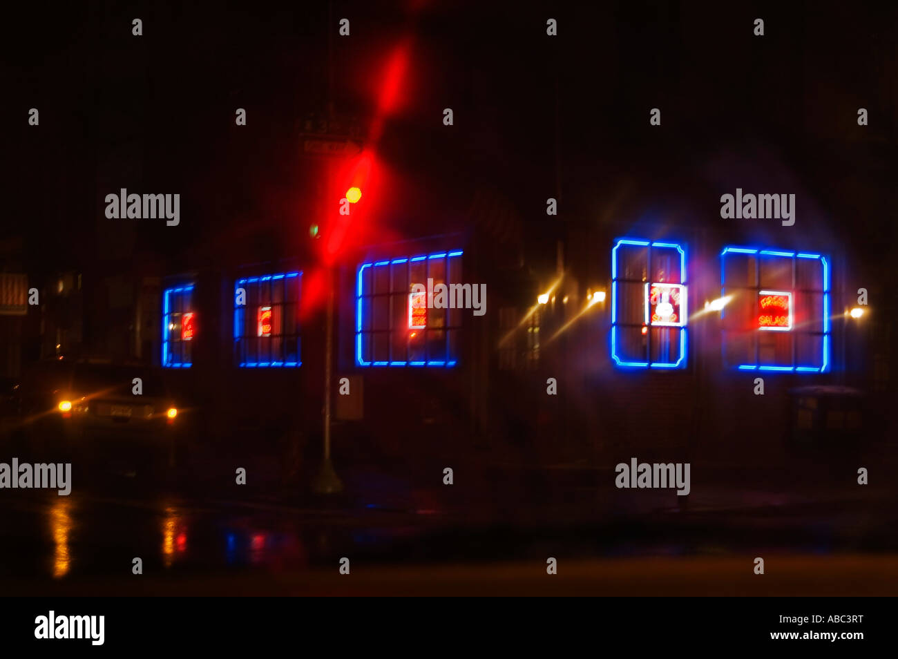 urban night street scene neon lights red blue Stock Photo - Alamy