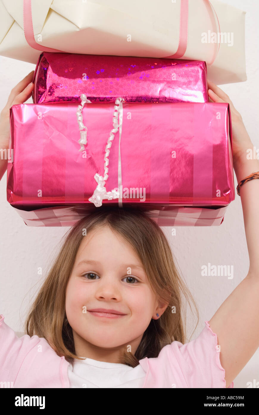 portrait of girl carrying presents on her head Stock Photo - Alamy