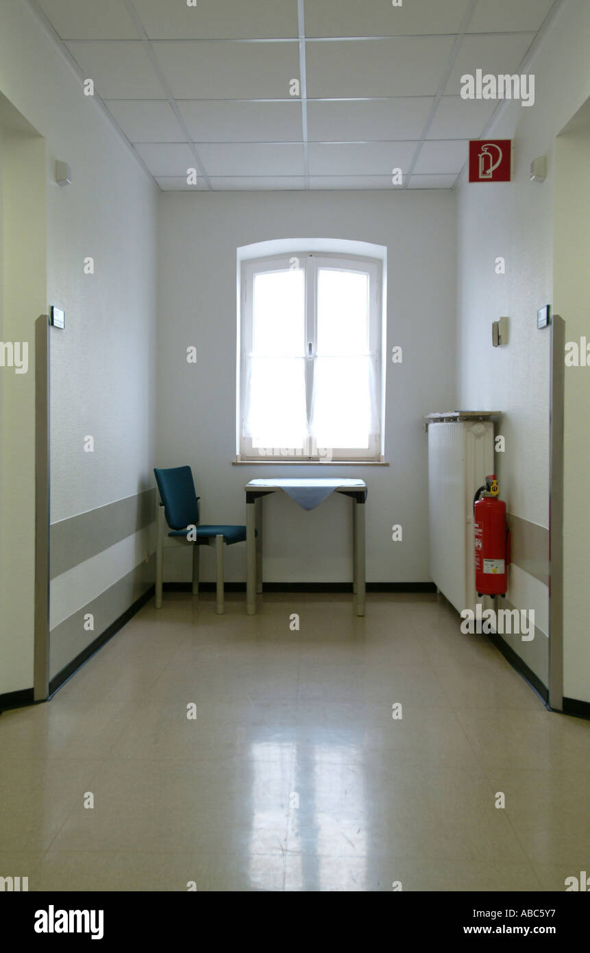 Table with chair in front of window in hospital Stock Photo - Alamy