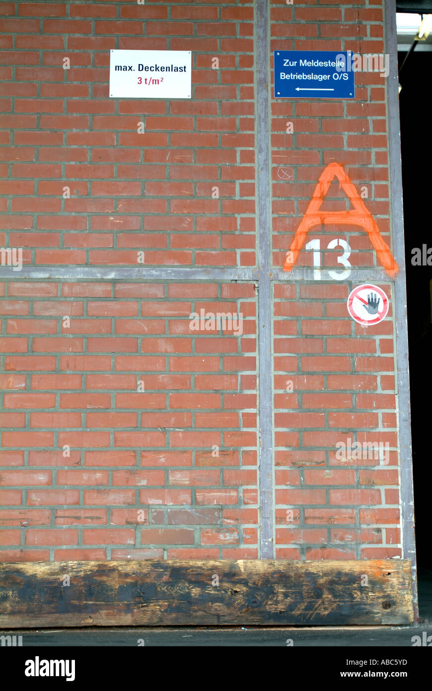 Brick wall with labels and organe letter A Stock Photo - Alamy