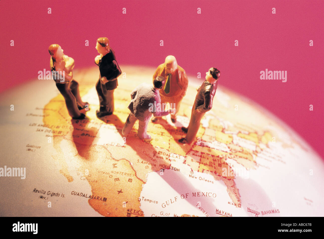 Figures on Globe Stock Photo - Alamy