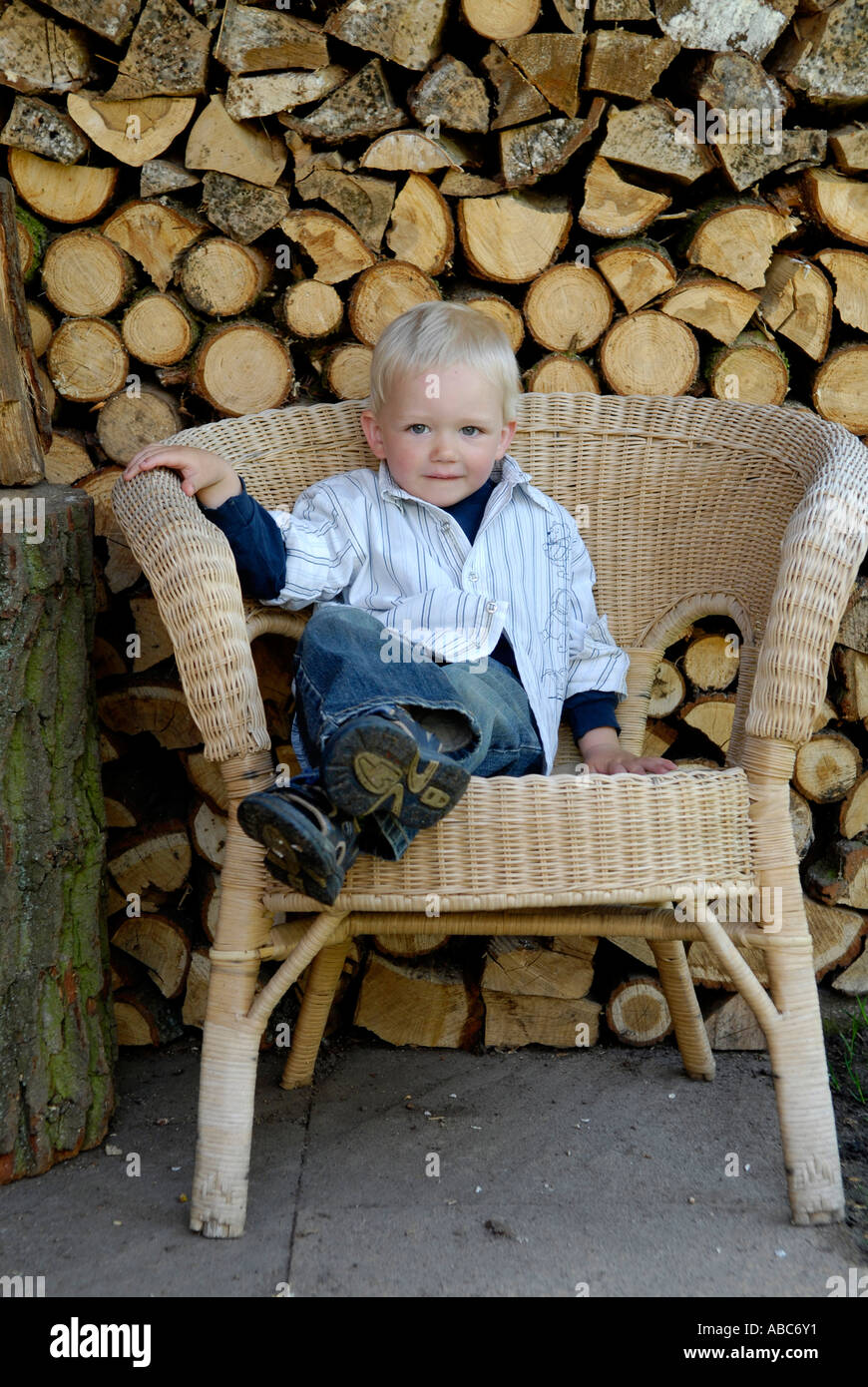 Boy sits on chair Stock Photo - Alamy