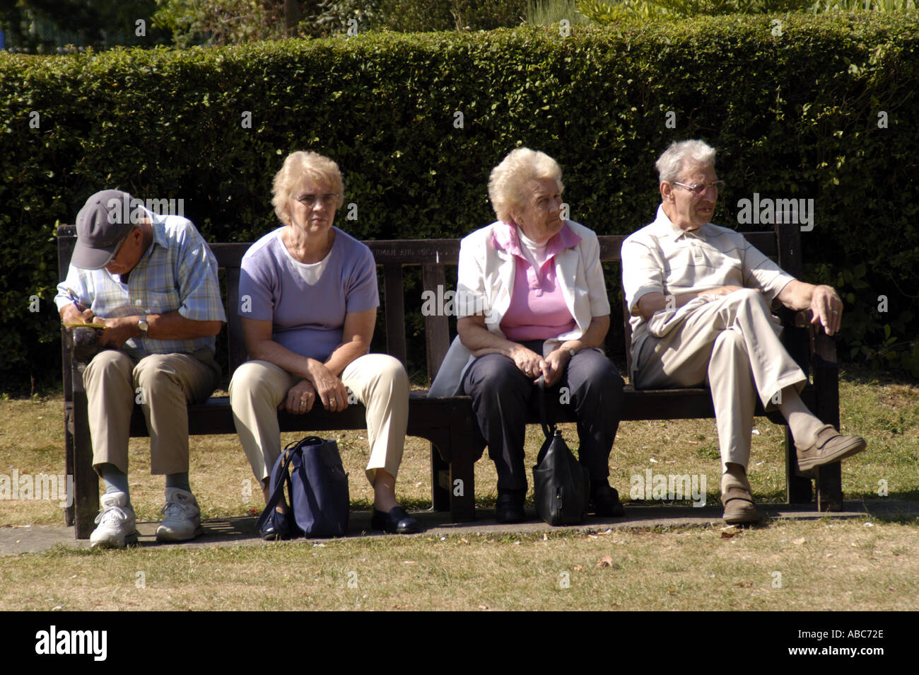 Old people on park bench Stock Photo - Alamy