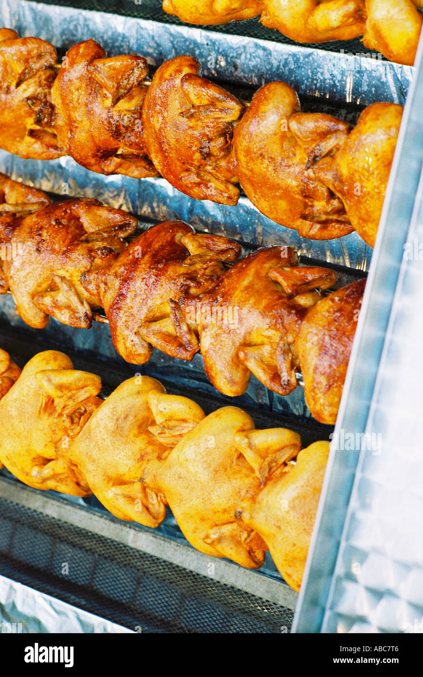 Pierced roast fried chicken broiler Stock Photo - Alamy