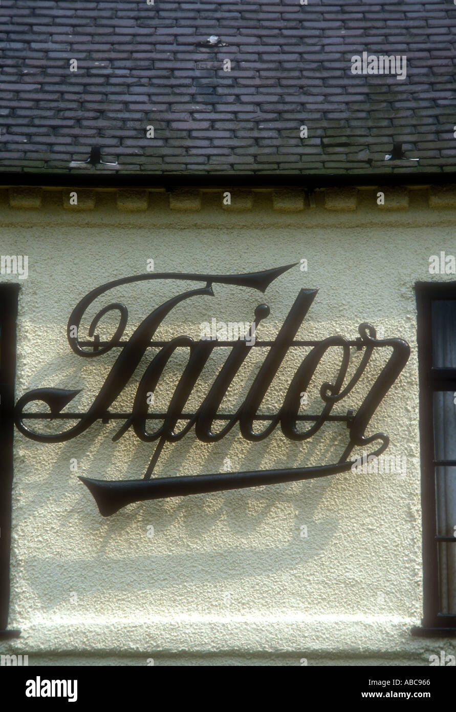 An elaborate Tailors Shop sign in Cambridgeshire England Stock Photo ...