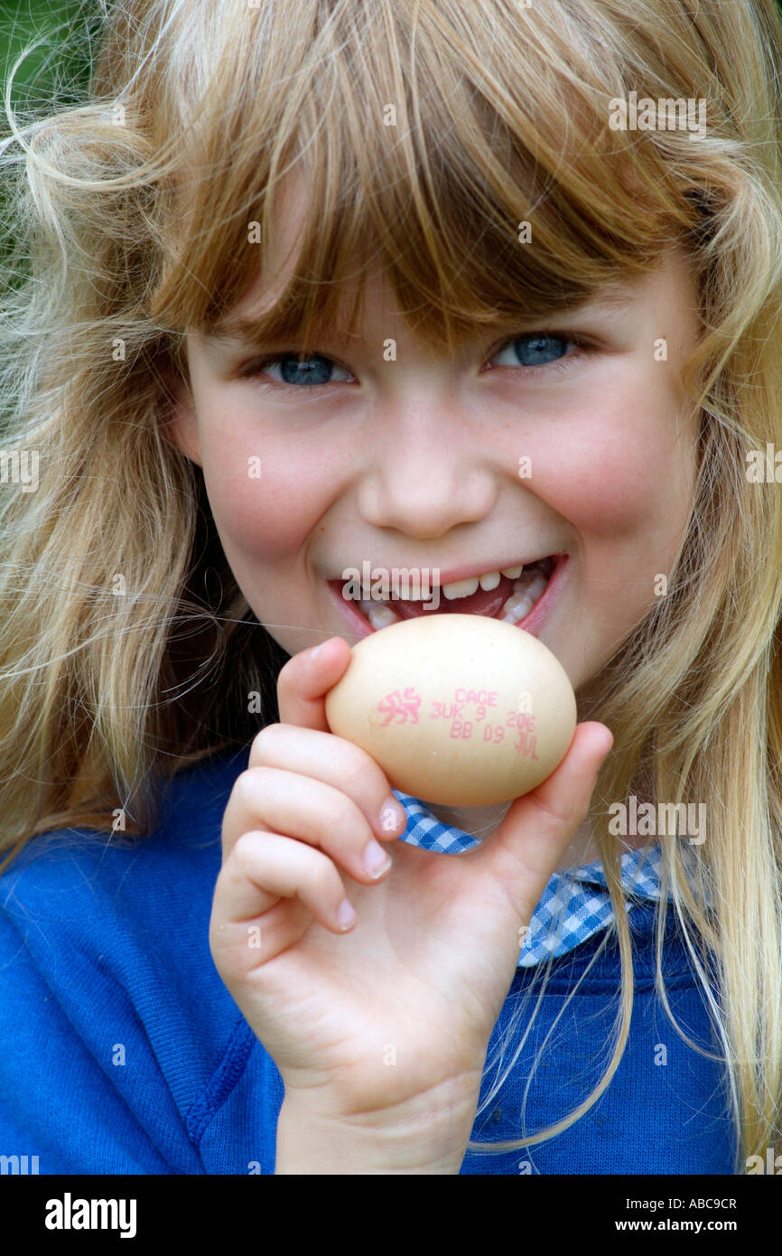 Young girl holding a hens egg shows grading marks Stock Photo - Alamy