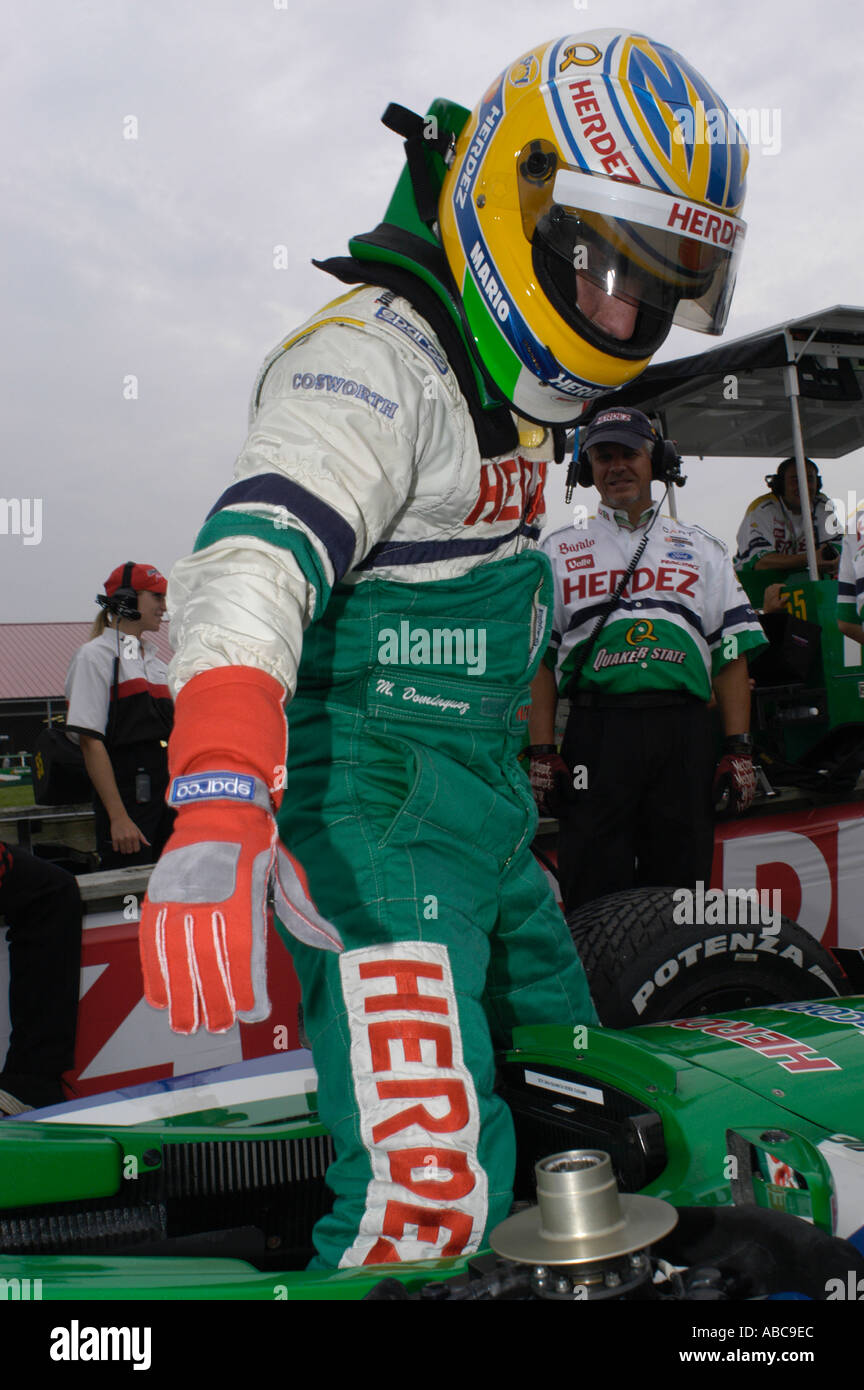 Mario Dominguez climbs into the cockpit of his racing car at the Champ ...