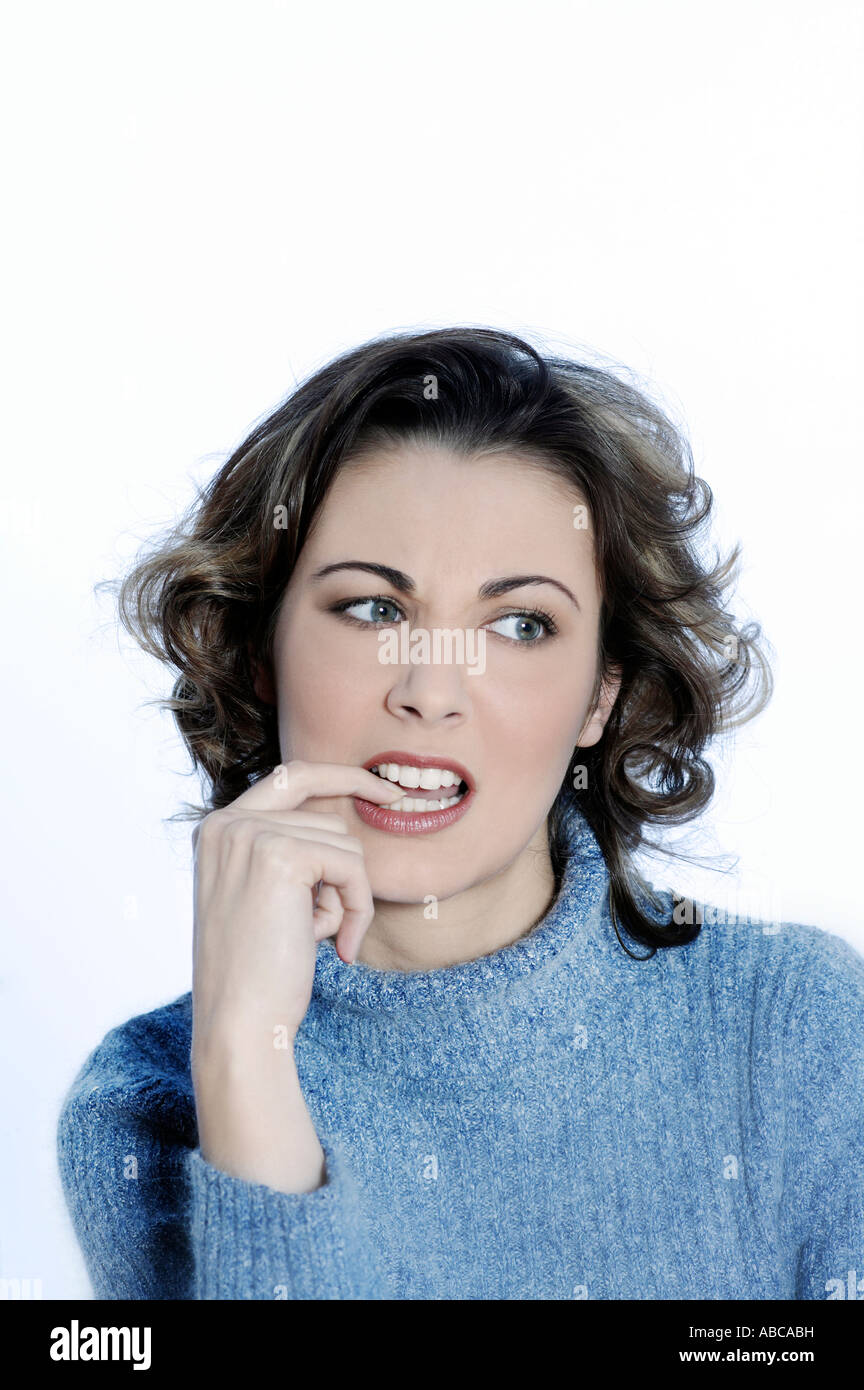 studio shot portraits of a young annoyed woman biting his finger Stock ...