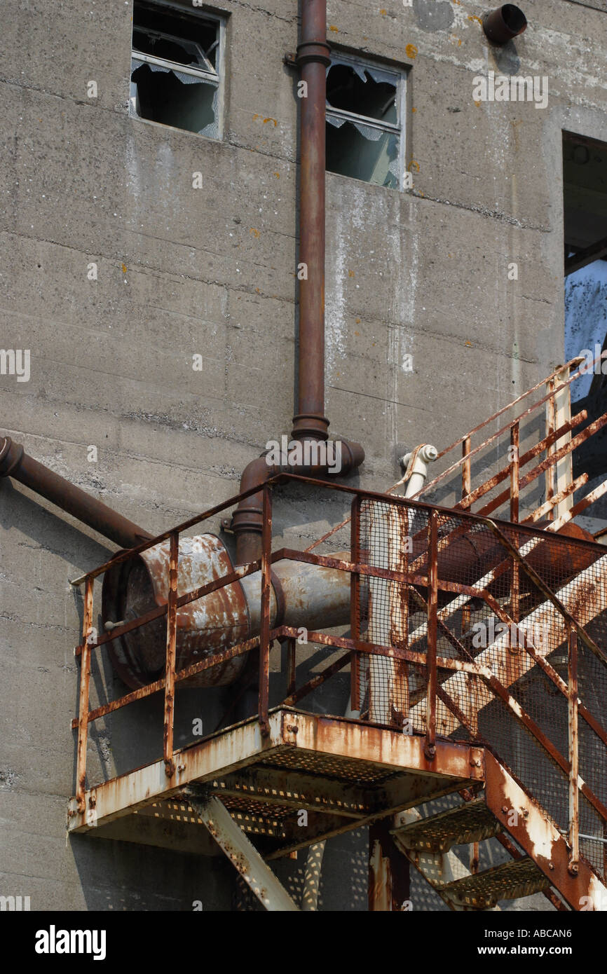 Rusty old emergency external staircase on outside of old derelict ...